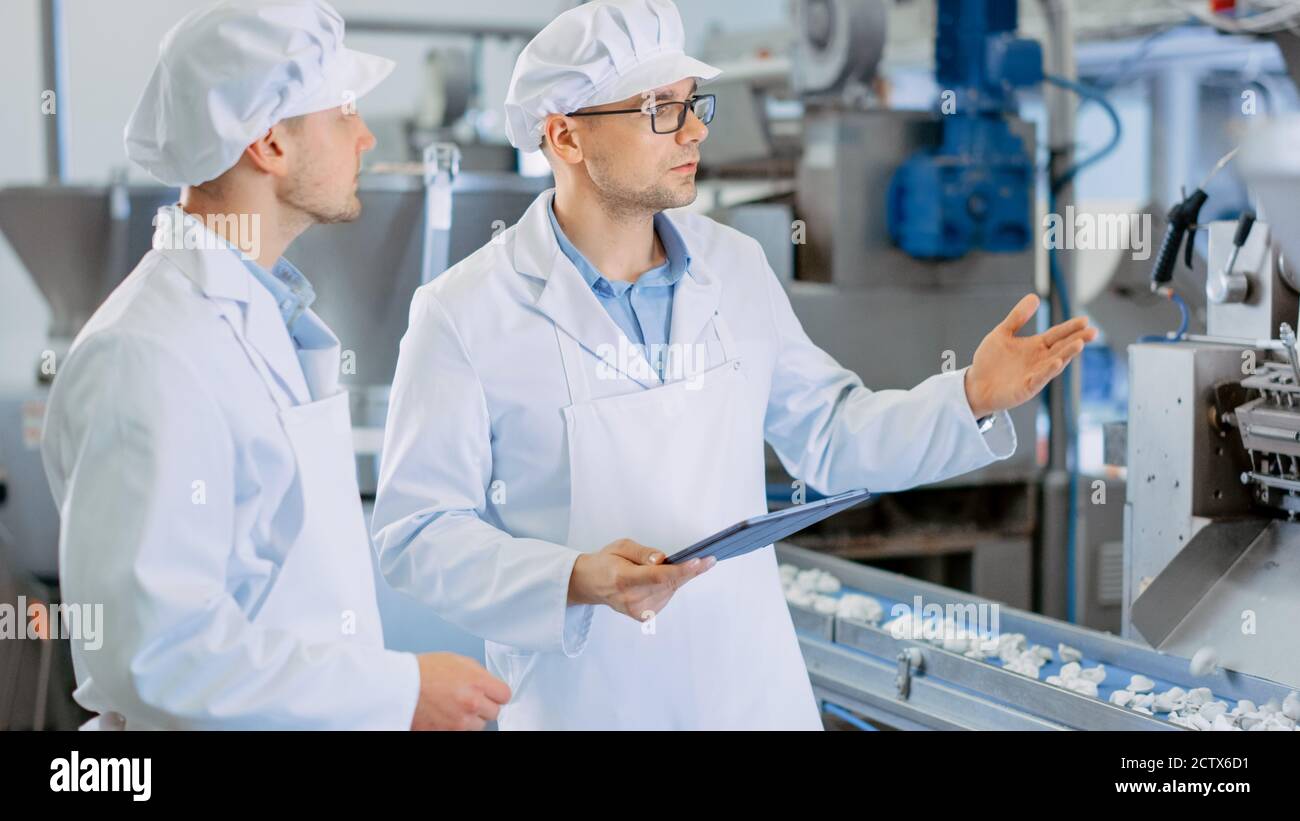 Two Young Male Quality Supervisors or Food Technicians are Inspecting ...