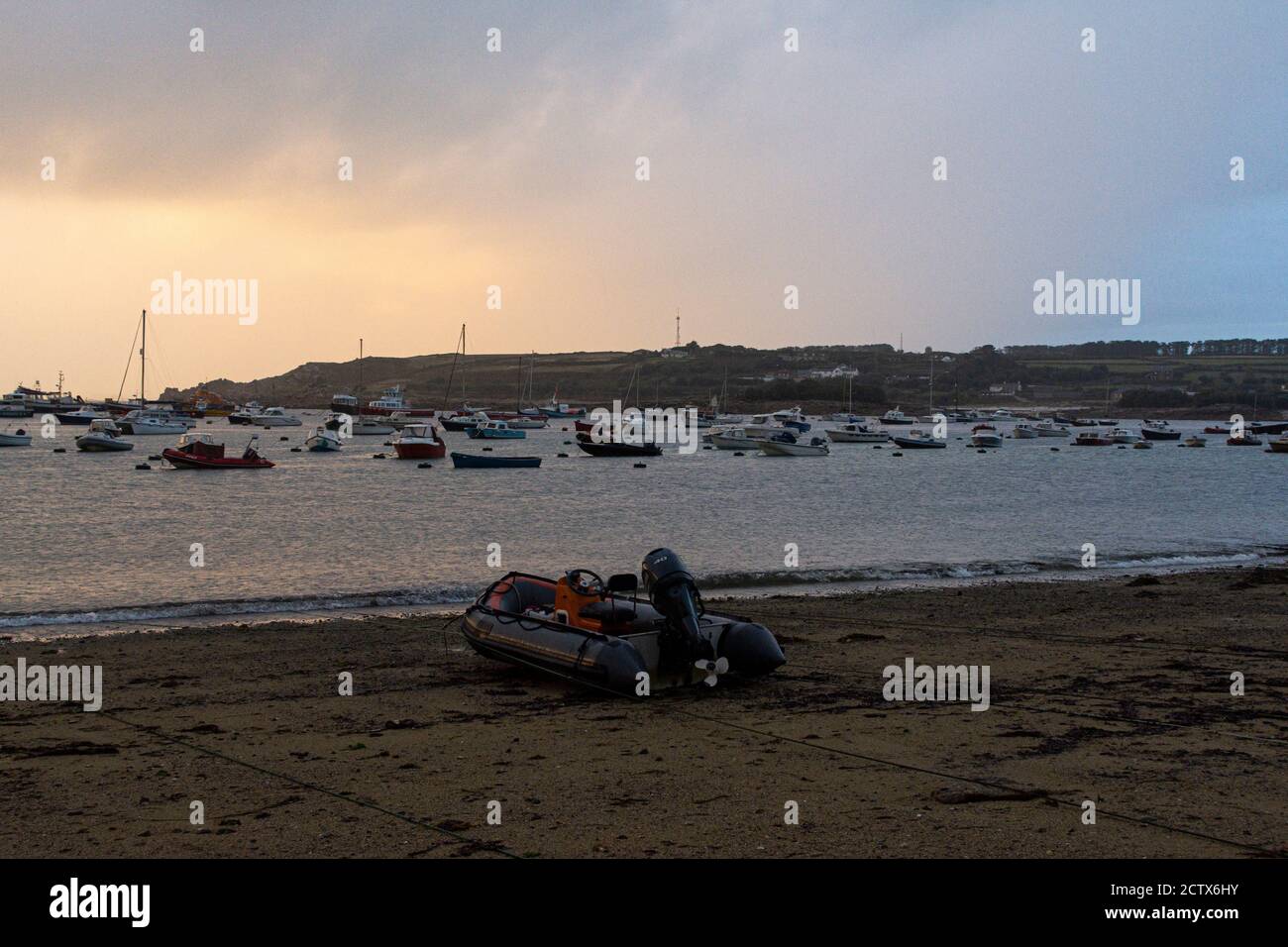 Boats in St Mary's Pool at dusk on the Isles of Scilly Stock Photo - Alamy