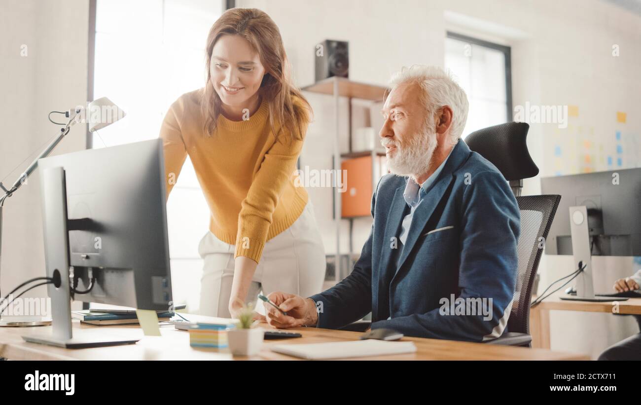 Handsome Middle Aged Creative Engineer Sitting at the Desk working on ...