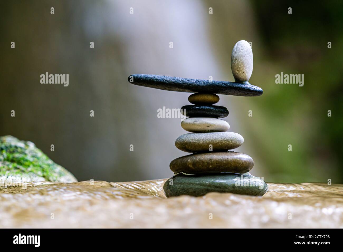 Balanced Zen stones pebbles at the waterfalls Stock Photo - Alamy