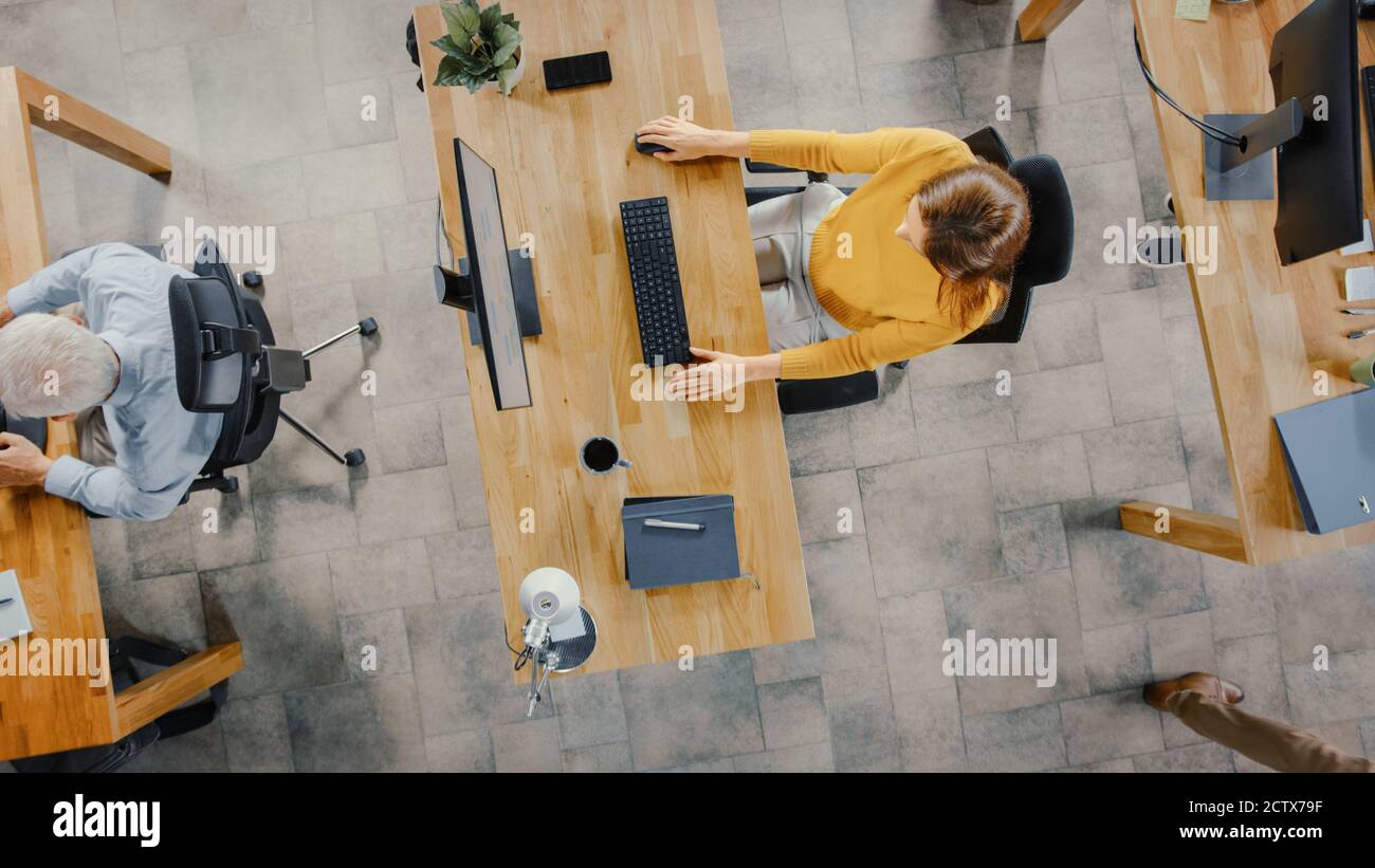Top View Shot in the Office: Beautiful Young Female Specialist Sitting ...