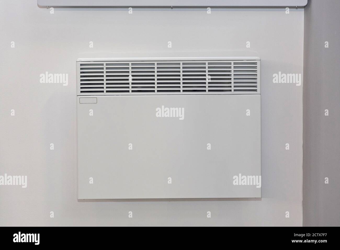 White Electric Heater Radiator at Office Wall Stock Photo - Alamy
