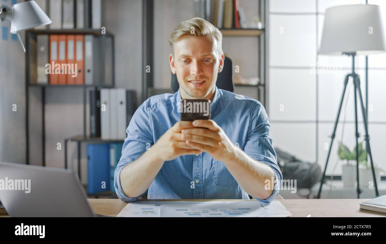 Creative Entrepreneur Sitting at His Desk Works on a Laptop in the ...