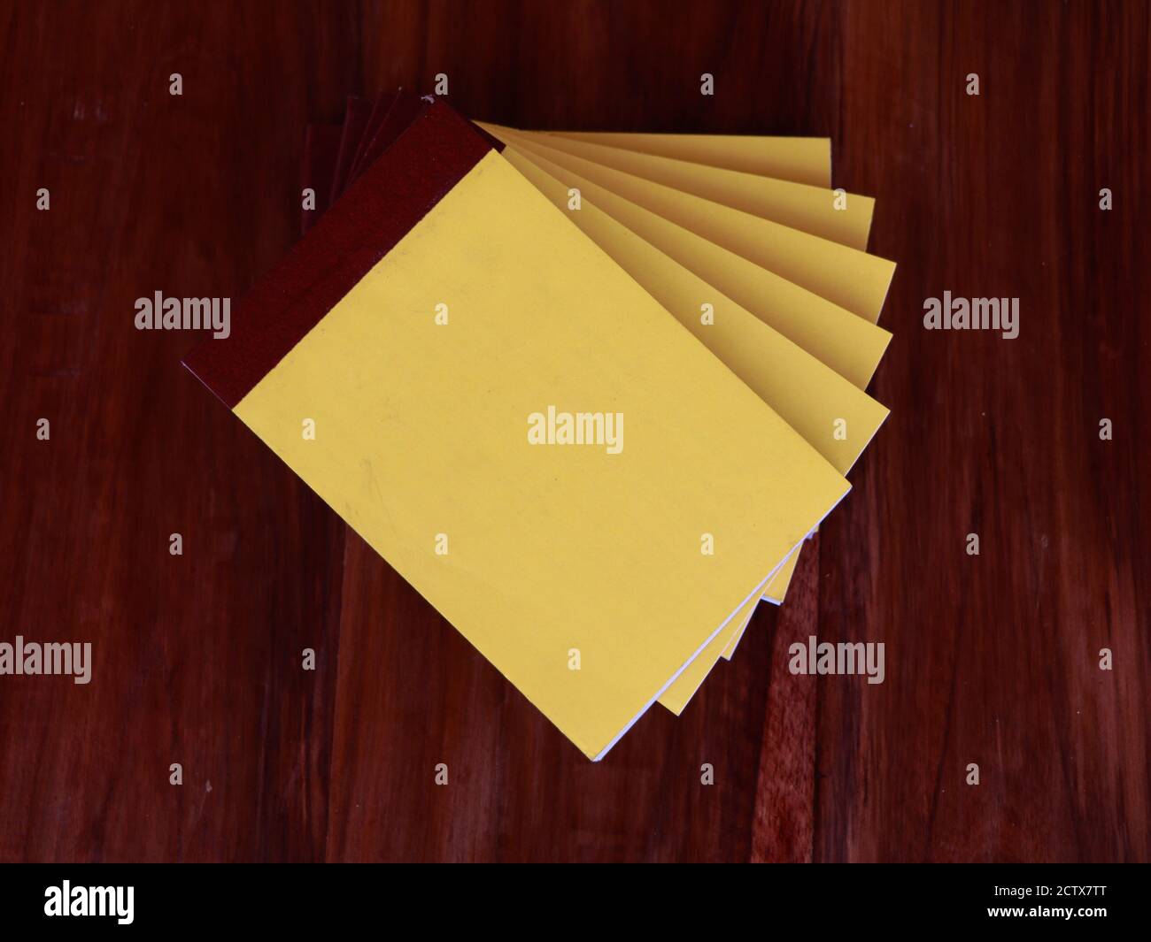 Yellow color bill books or receipt books on a wooden surface, close up ...