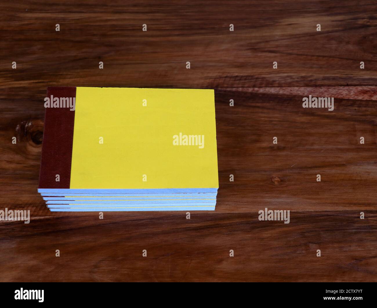 Yellow color bill books or receipt books on a wooden surface, close up ...