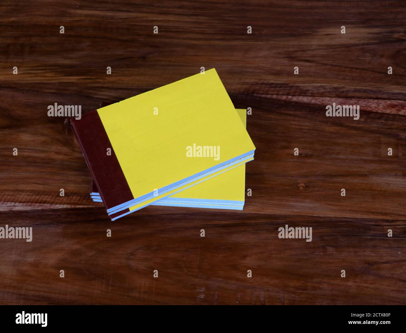 Yellow color bill books or receipt books on a wooden surface, close up ...