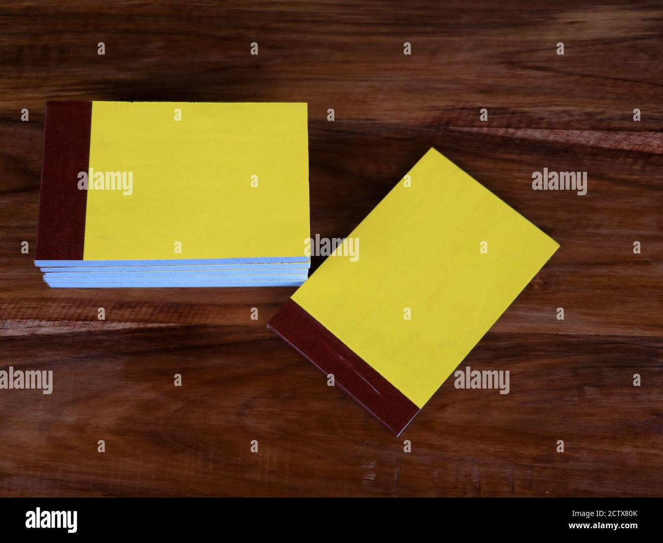 Yellow color bill books or receipt books on a wooden surface, close up ...