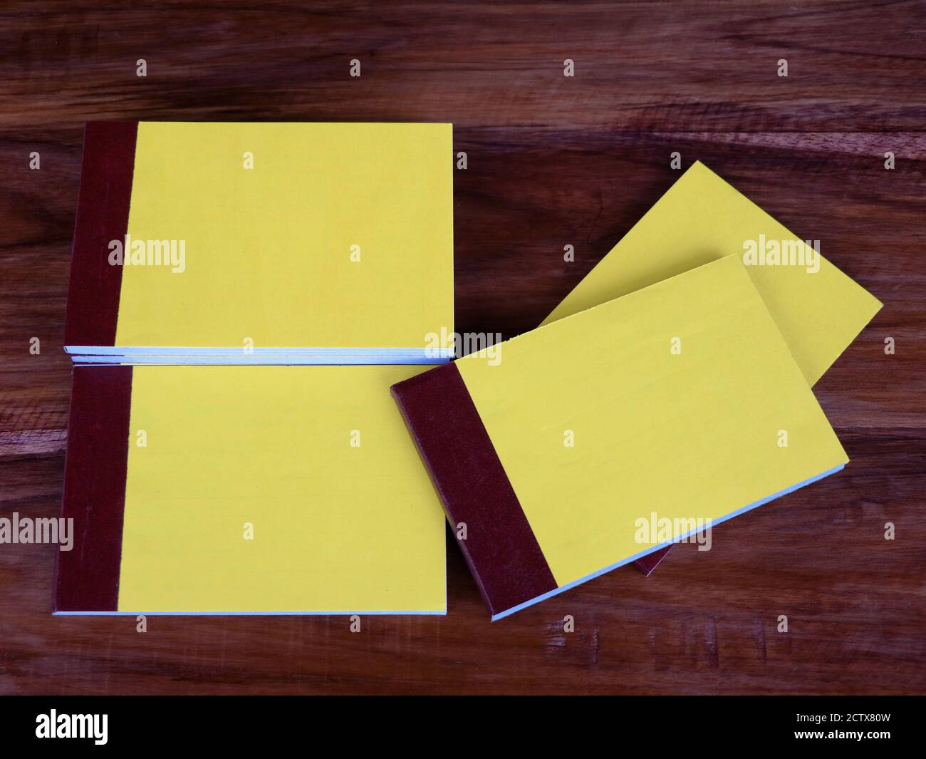 Yellow color bill books or receipt books on a wooden surface, close up ...