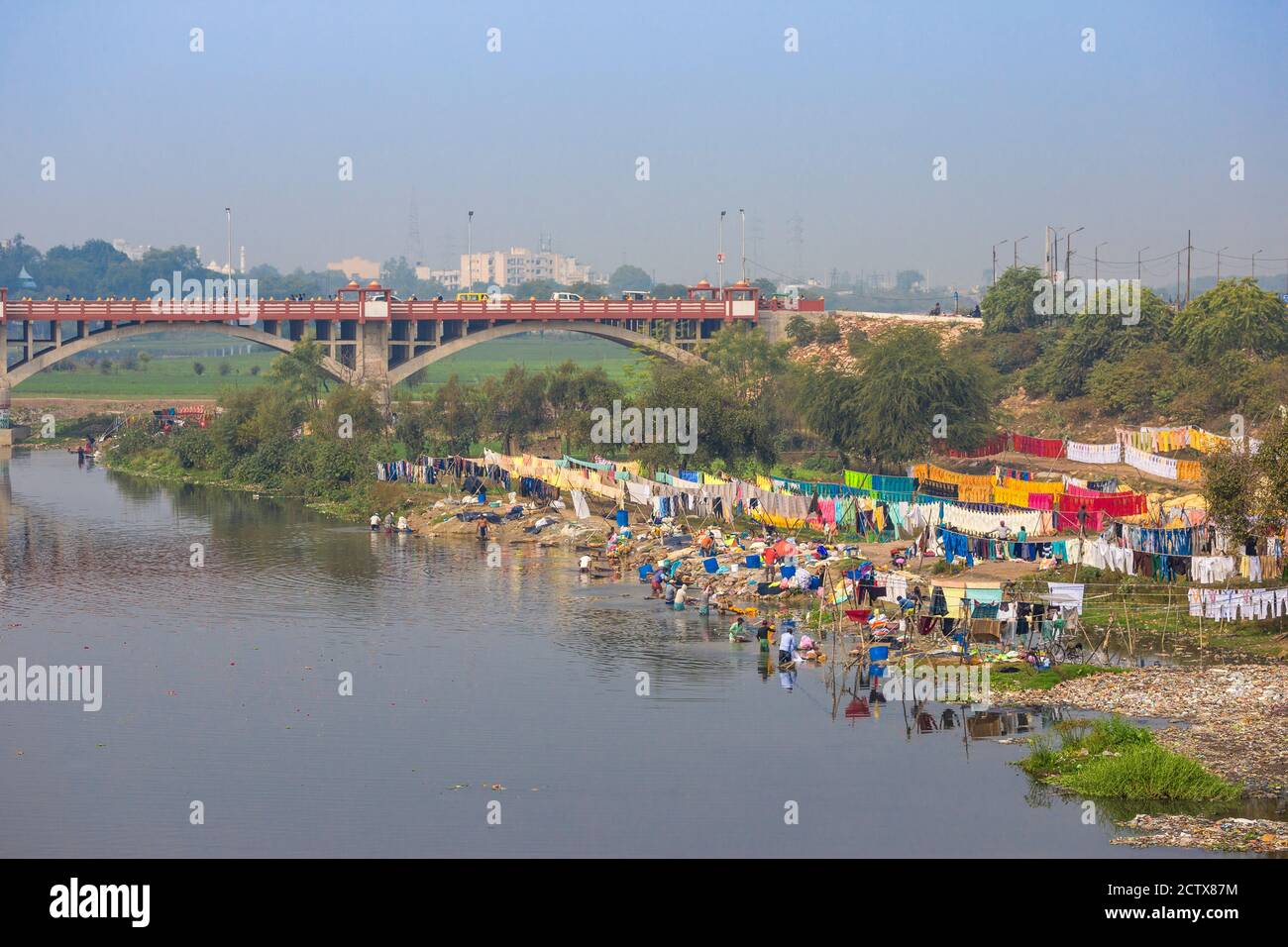 India, Uttar Pradesh, Lucknow, Washing drying on banks of Gomti River ...