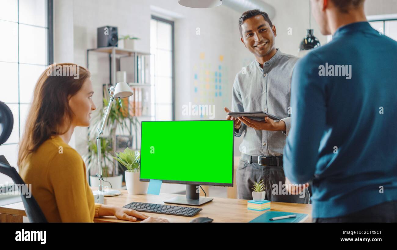 Three Start-up Entrepreneurs Work on Desktop Computer with Green Mock ...