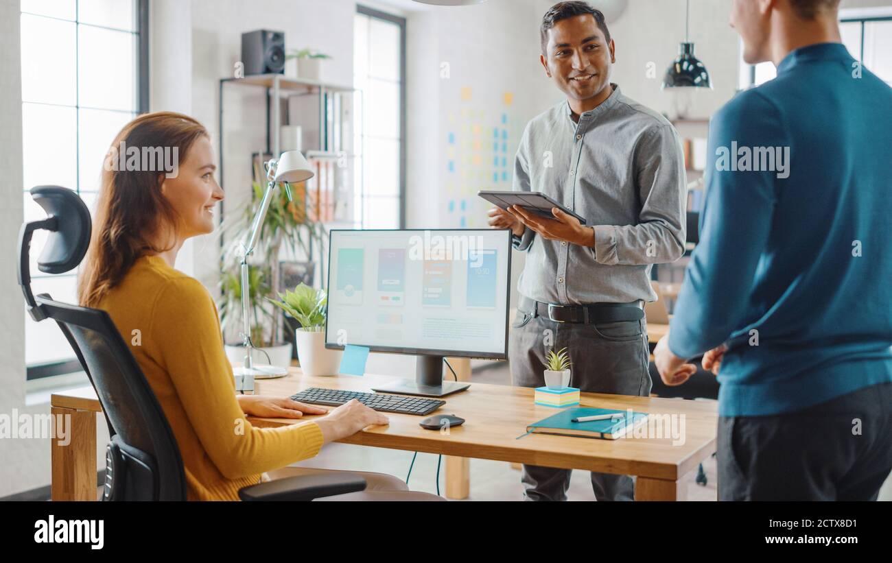 Three Mobile Software Developers Work on Desktop Computer, They Discuss ...