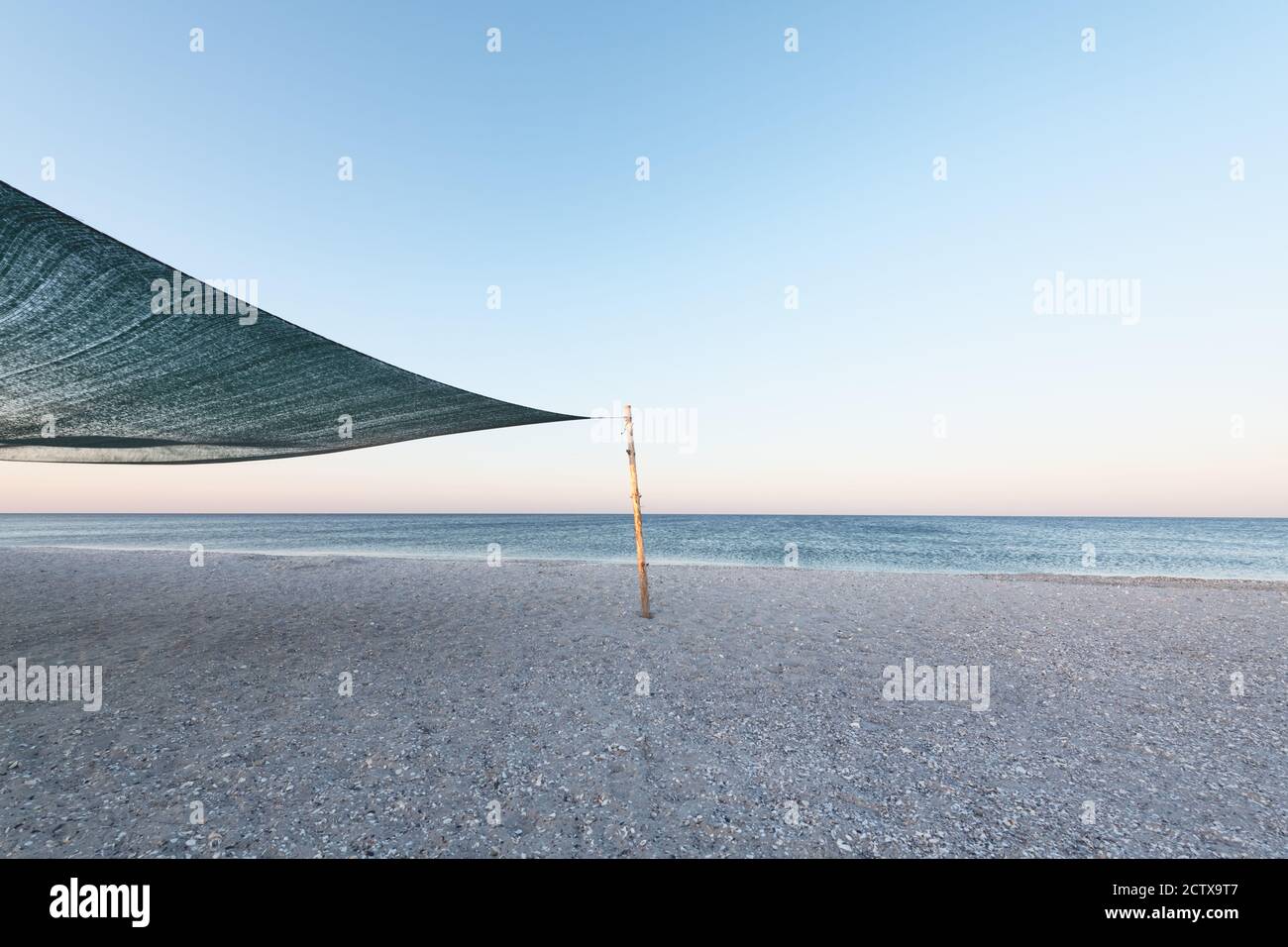 Shelter from the sun on tropical beach sand and blue sea water ...