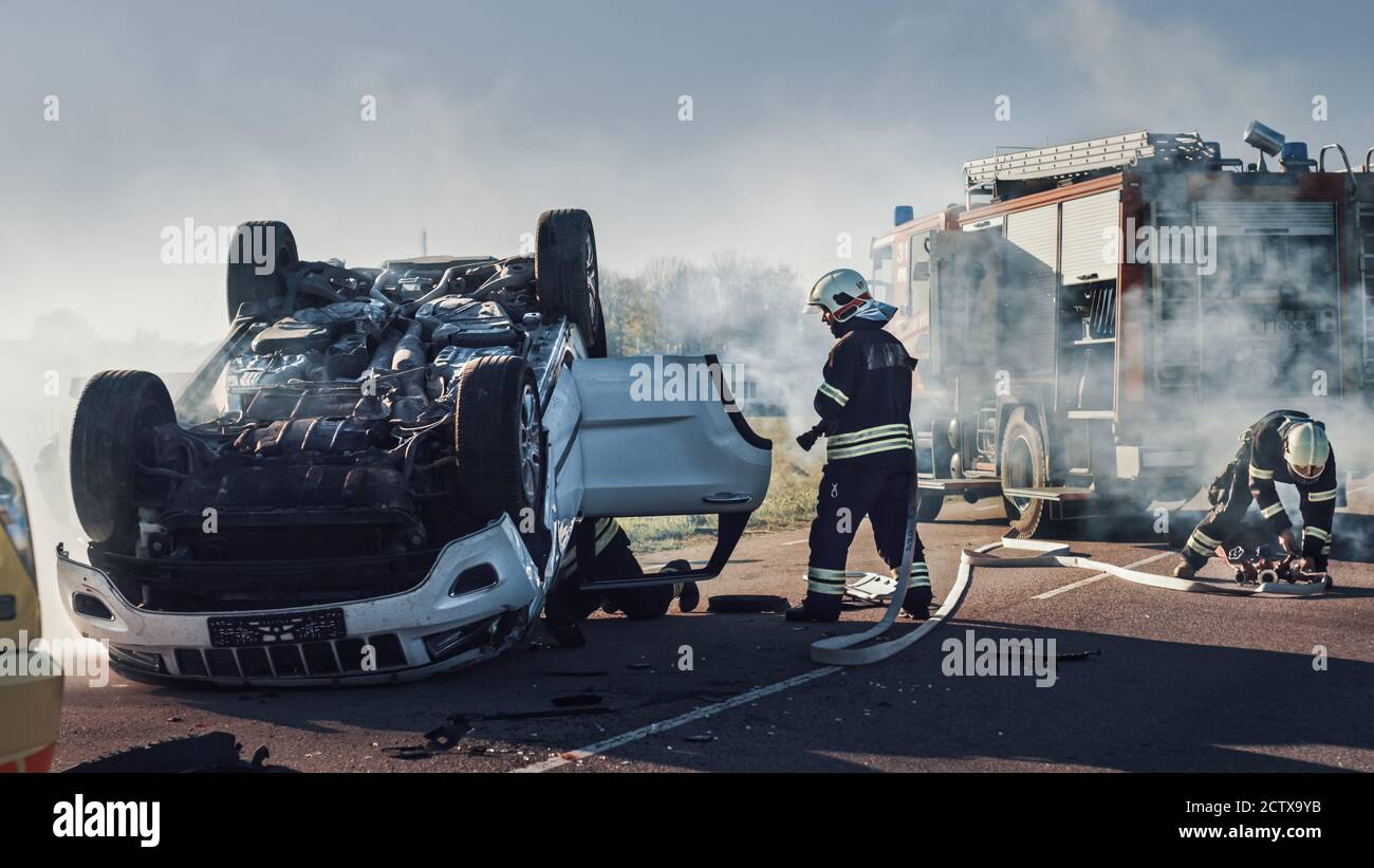 Rescue Team of Firefighters Arrive on the Car Crash Traffic Accident ...