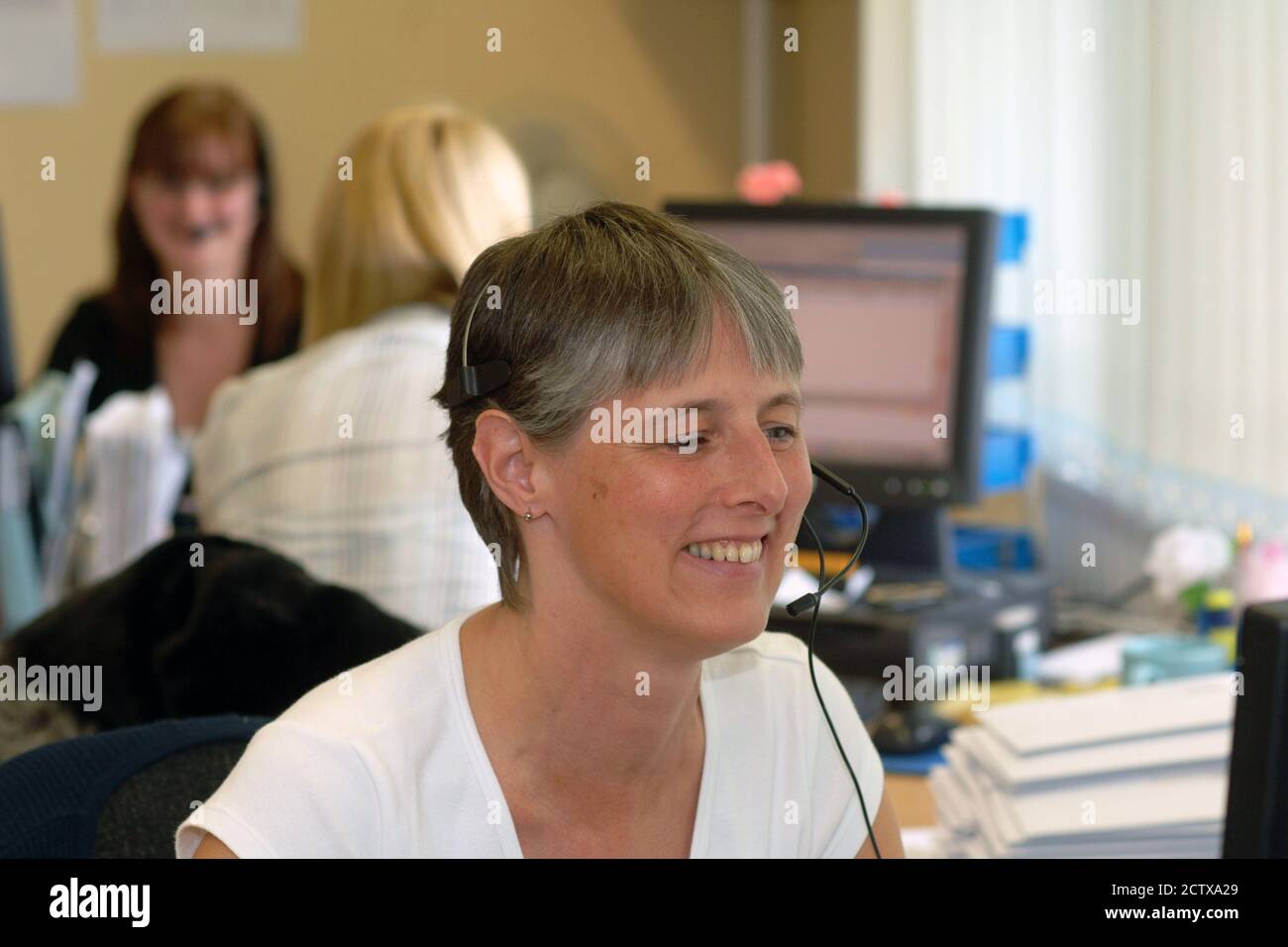 Call centre worker on the telephone; NHS Stock Photo - Alamy