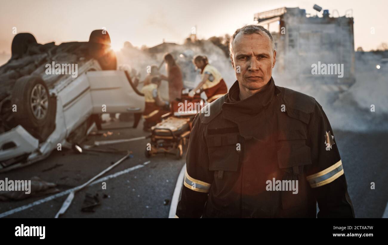 Portrait of the Brave Firefighter Walking to the Camera. In Background ...