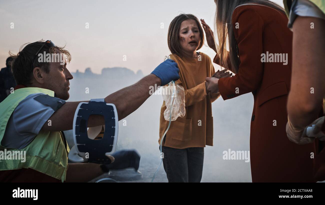 Team of Paramedics Perform Emergency First Aid to Injured Mother and ...