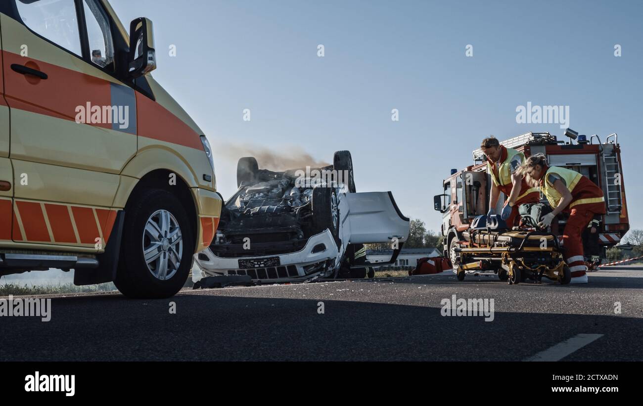 Rescue Team of Firefighters and Paramedics Work on a Terrible Car Crash ...
