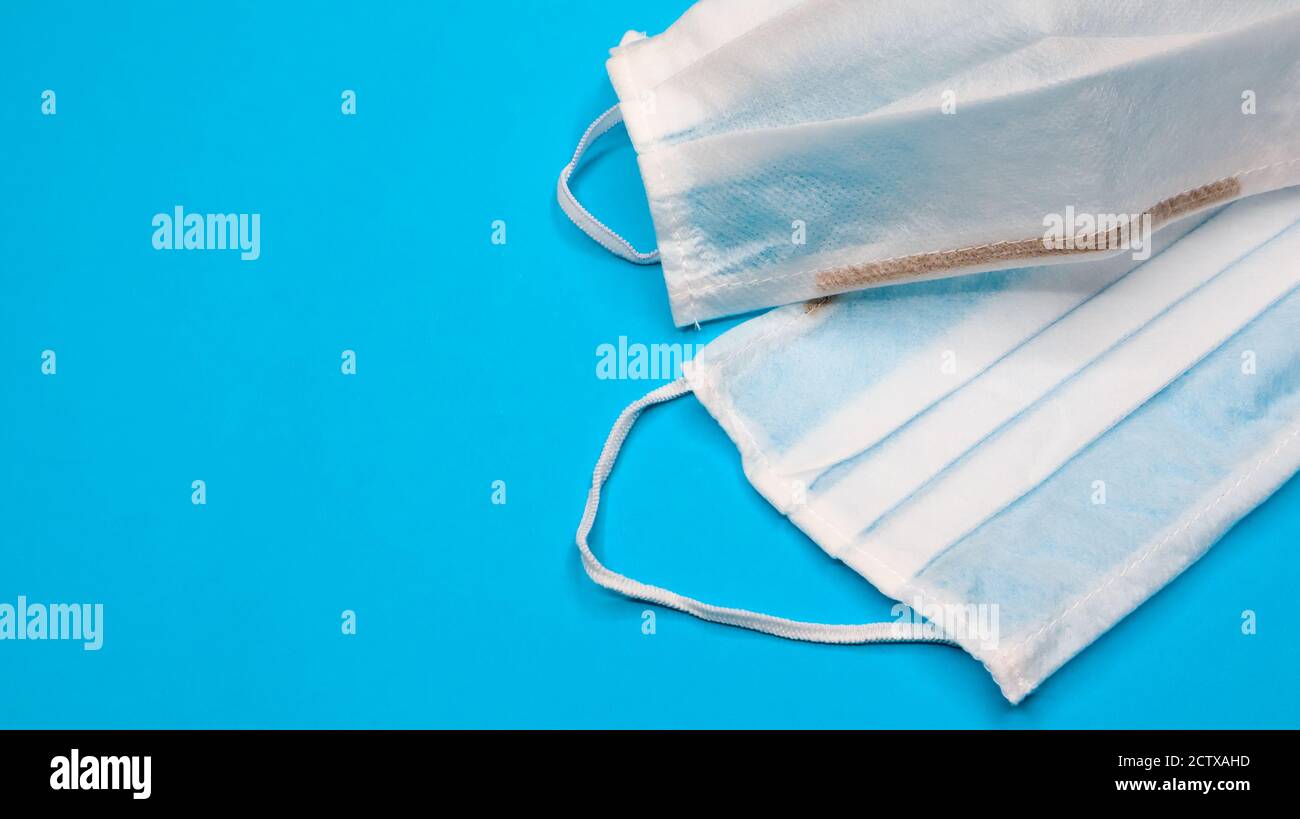 Two disposable surgical face masks with rubber pads to cover the mouth ...