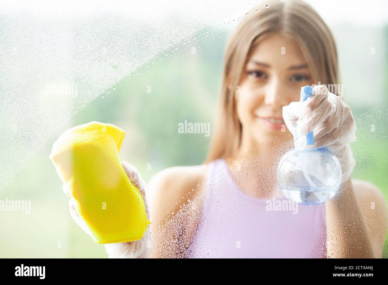 Young Smiling Woman Washing Window with Sponge Stock Photo - Alamy