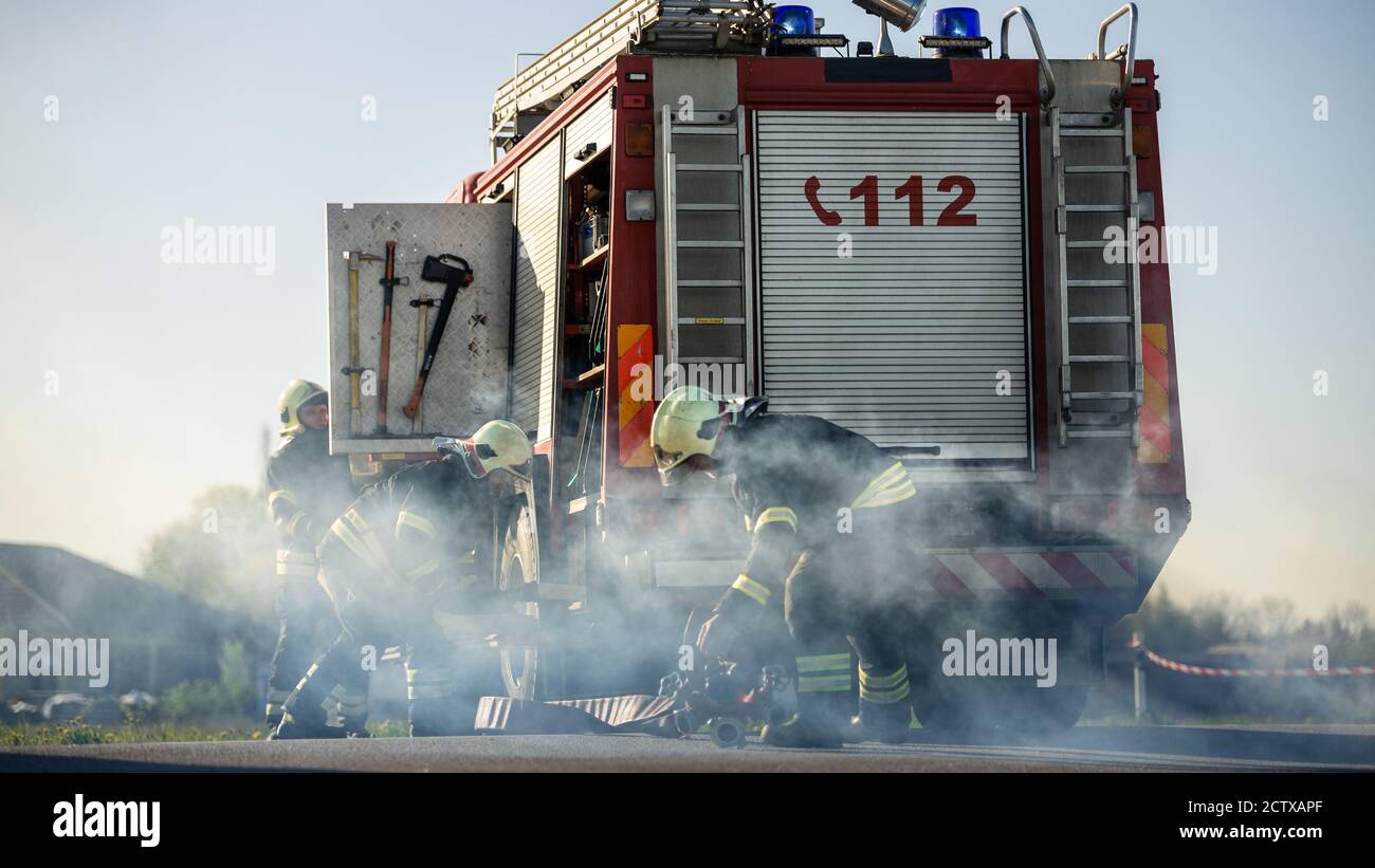 Rescue Team of Firefighters Arrive on the Car Crash Traffic Accident ...