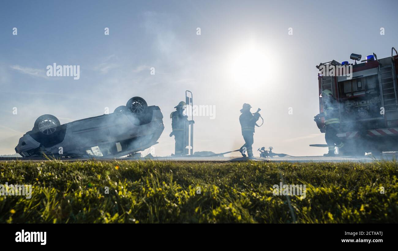 On the Car Crash Traffic Accident Scene: Firefighters Rescue Injured ...