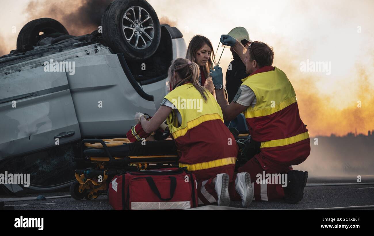 On the Car Crash Traffic Accident Scene: Paramedics Perform First Aid ...