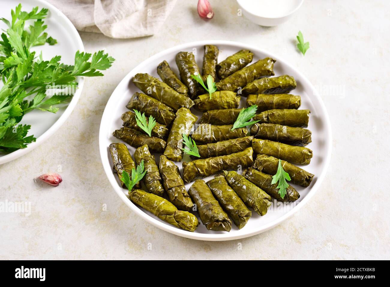 Dolma, stuffed grape leaves with rice and meat on light stone ...
