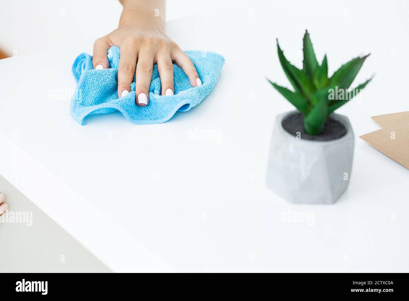 Cleaner tidies up the computer desk in the office Stock Photo - Alamy