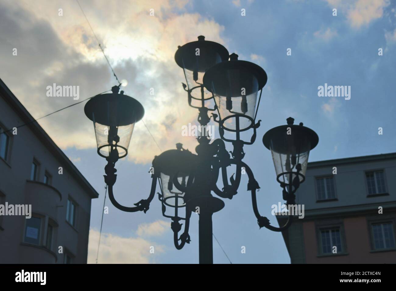 Silhouettes of historic street lamps in the pedestrian area of ...
