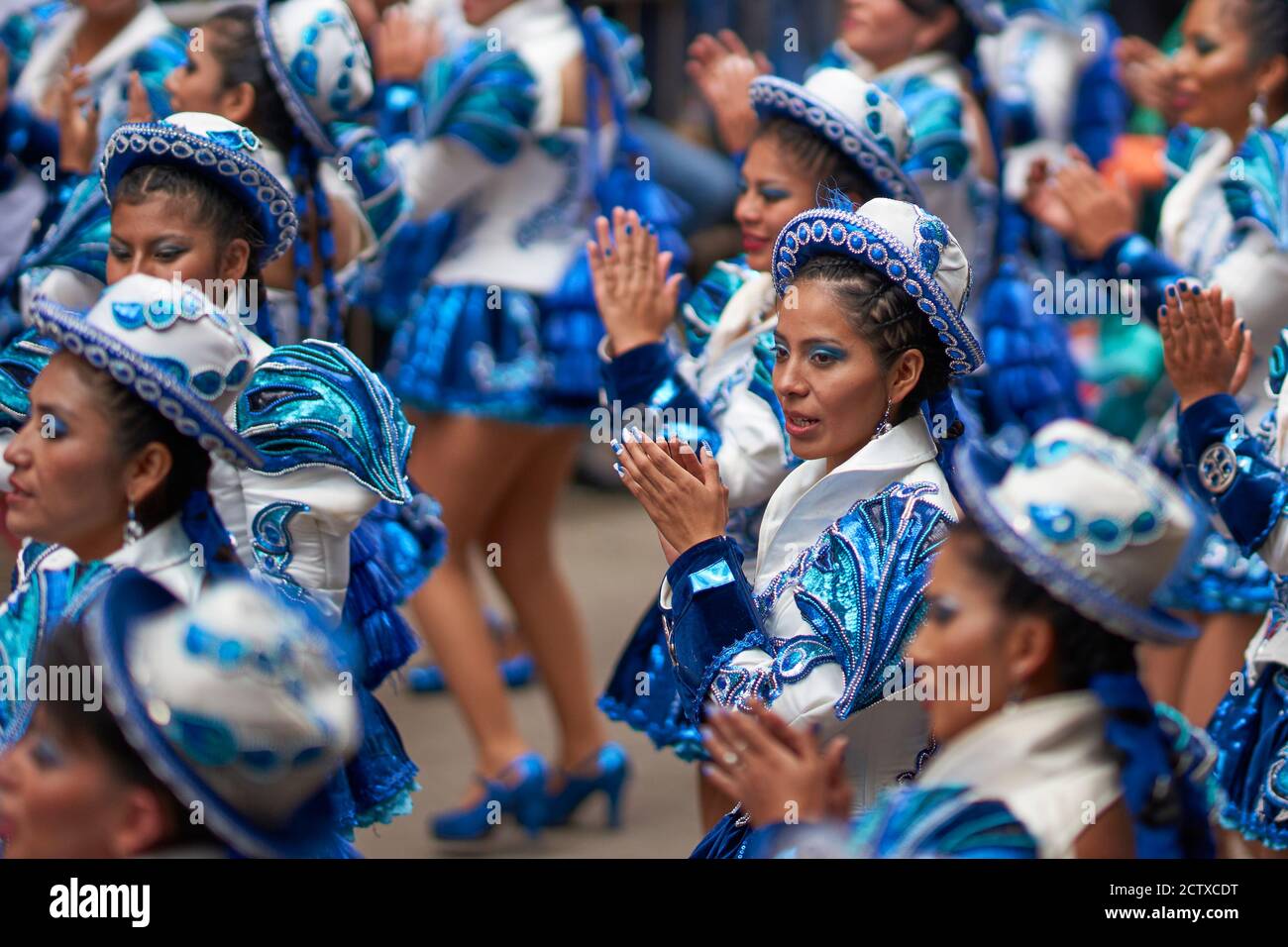 Caporales dancers in ornate costumes performing as they parade through ...