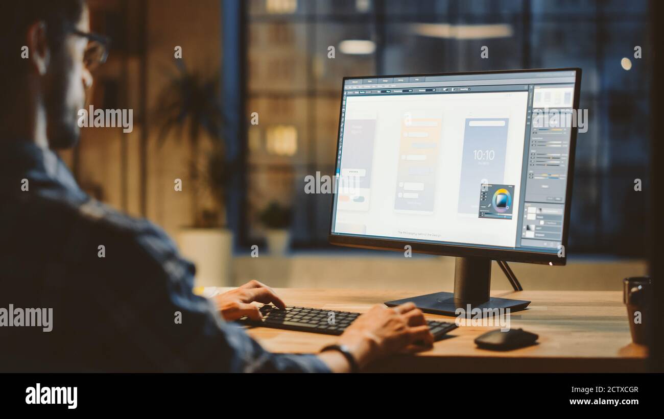 Over the Shoulder Shot of a Young App Developer Using Desktop Computer ...