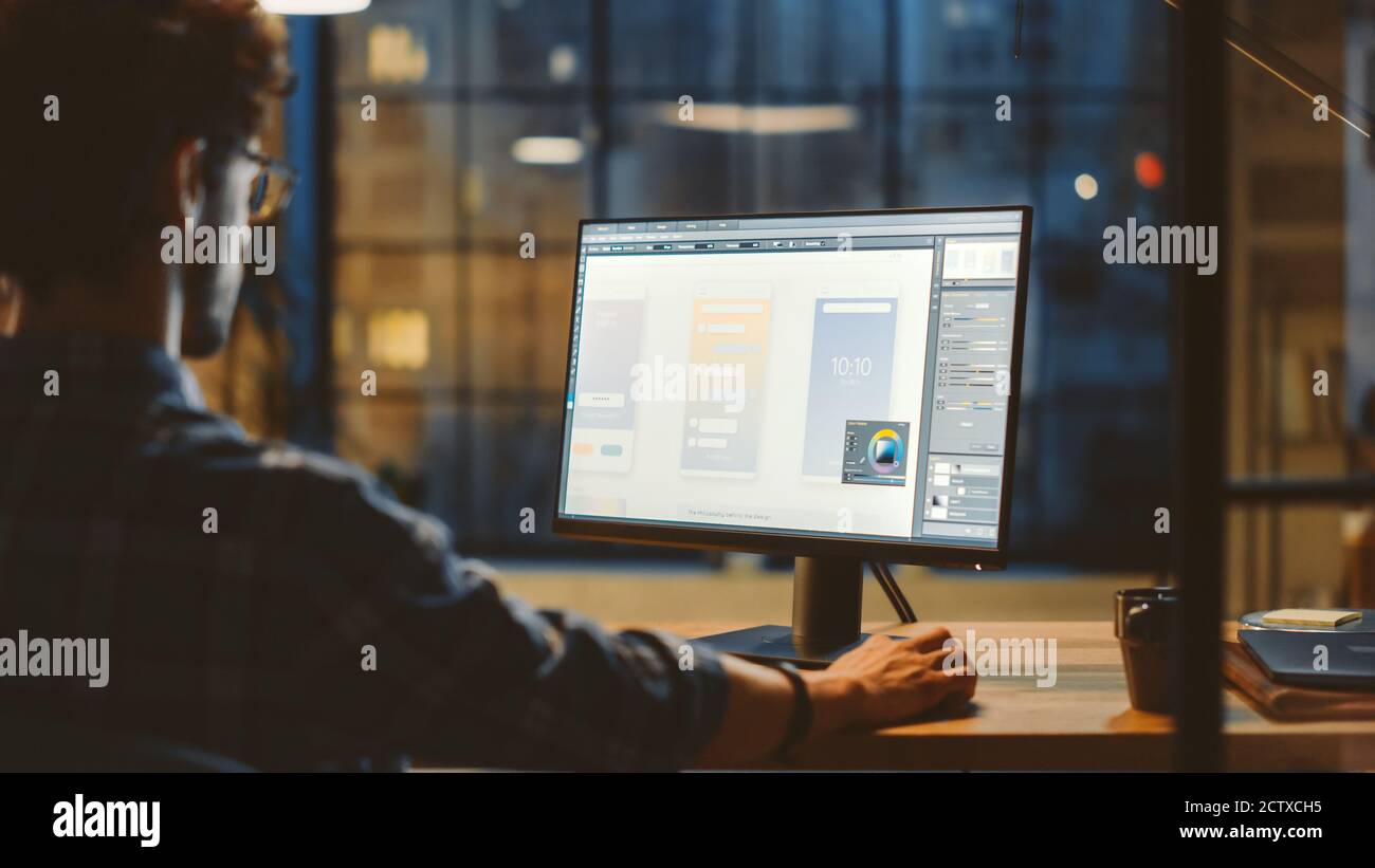 Over the Shoulder Shot of a Young App Developer Using Desktop Computer ...