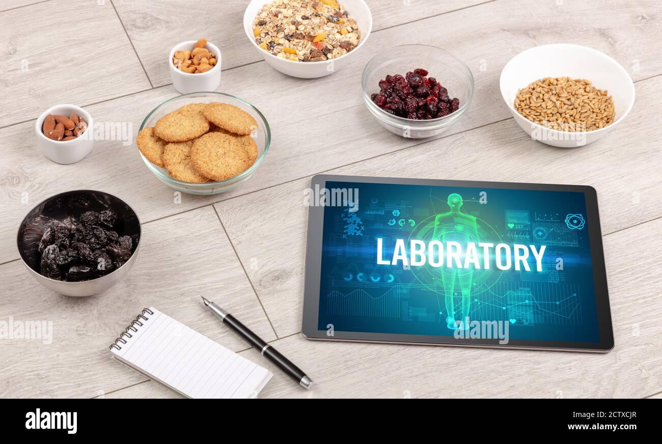 LABORATORY concept in tablet with fruits, top view Stock Photo - Alamy