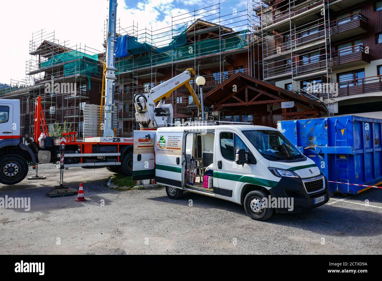 Building site with white van, lorry, crane and scaffolding, Puy St ...