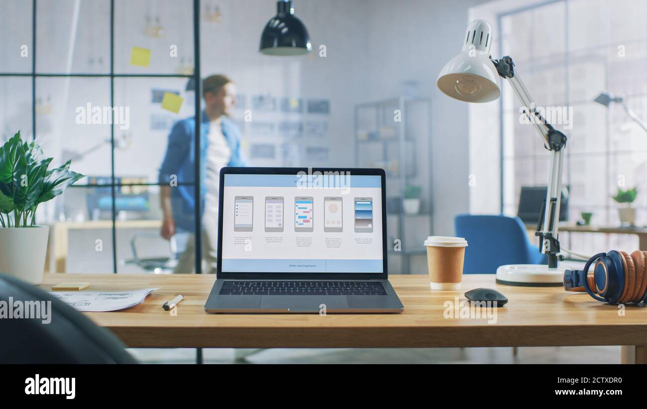 Laptop on the Desk in the Office Shows Screen with Mobile Phone ...