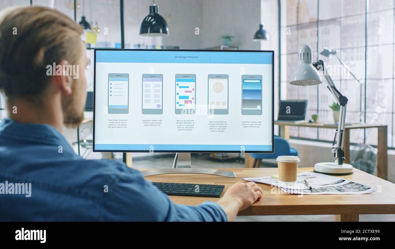 Young Professional Works on a Personal Computer at His Desk in the ...
