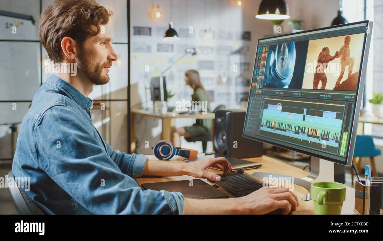 Male Video Editor with Beard and Jeans Shirt Works with Footage on His ...