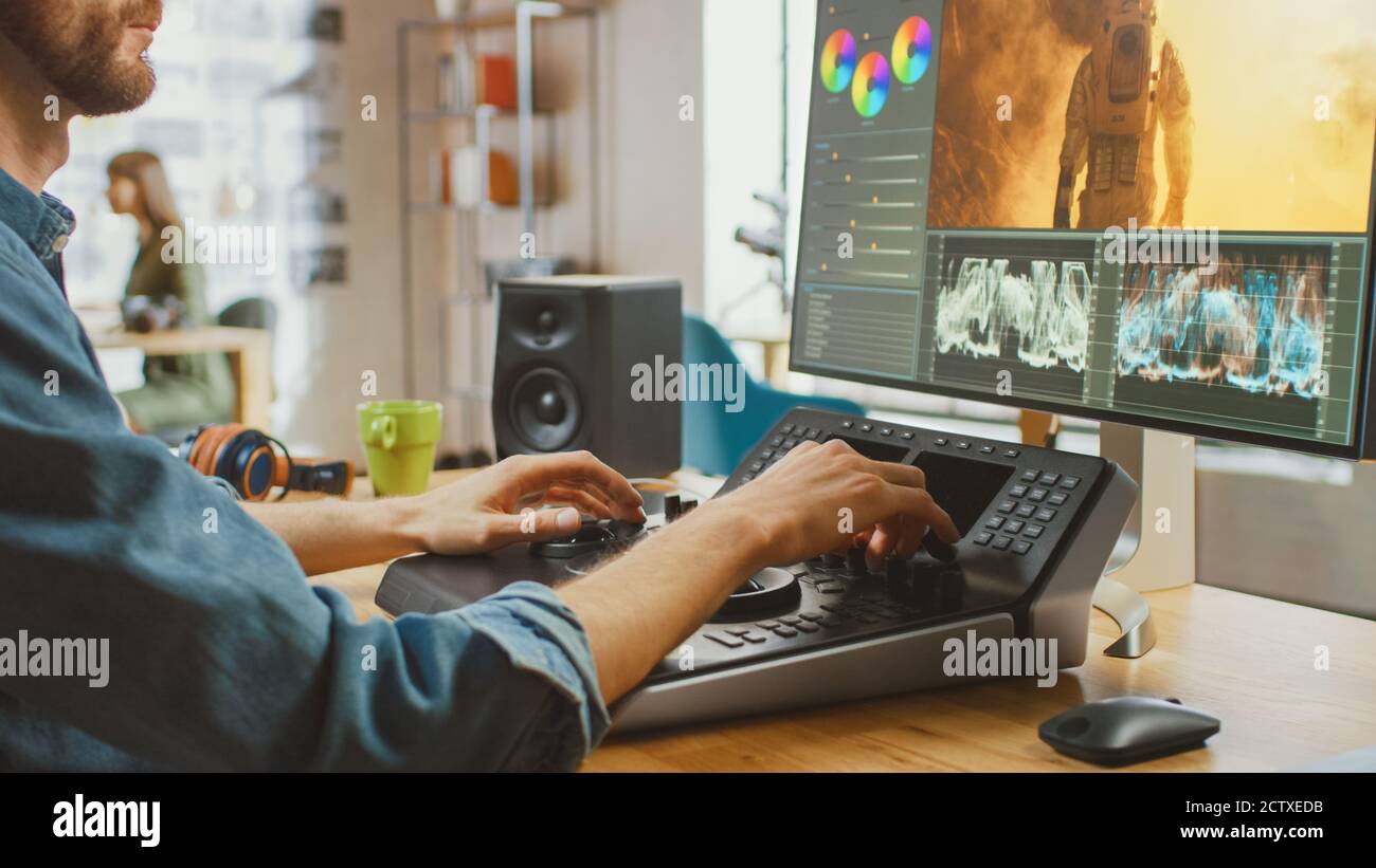 Male Video Editor with Beard and Jeans Shirt Works with Footage on His ...