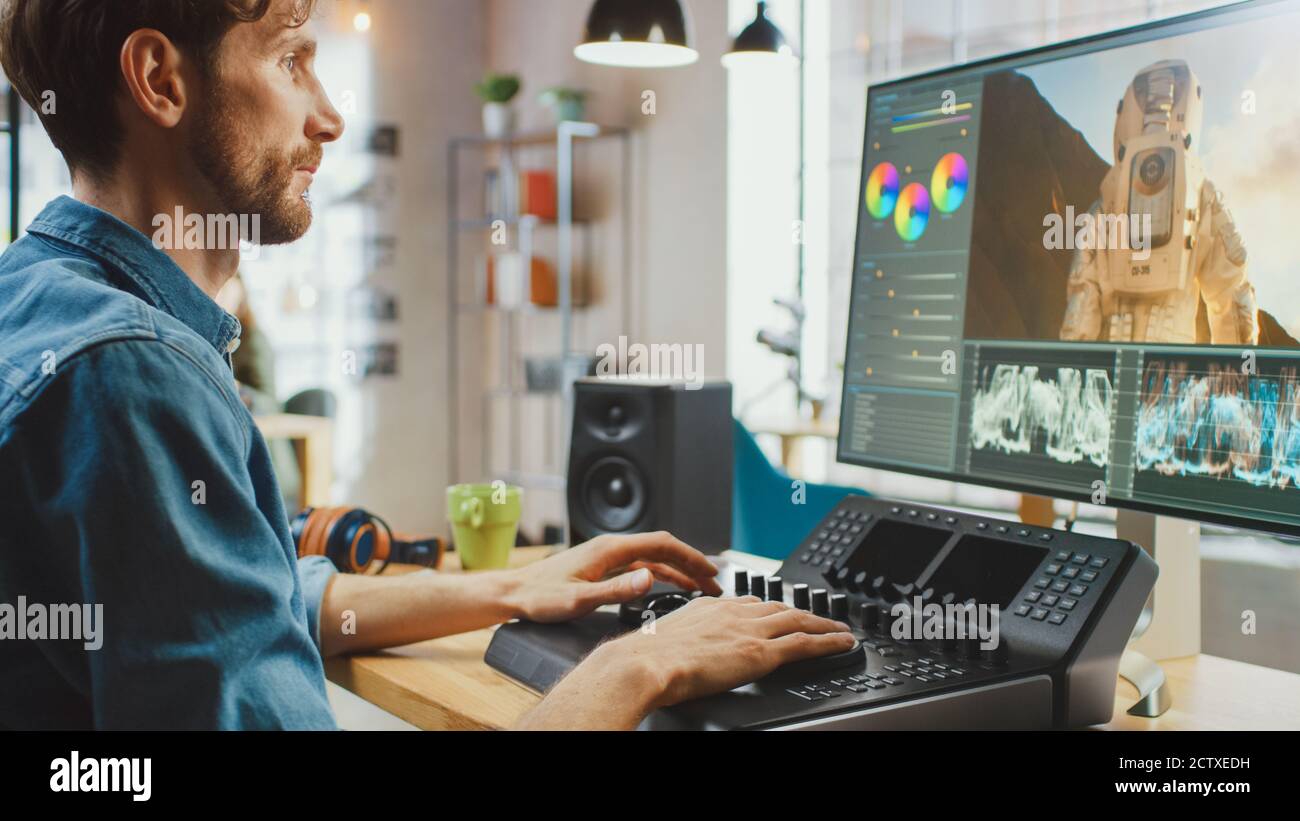 Male Video Editor with Beard and Jeans Shirt Works with Footage on His ...