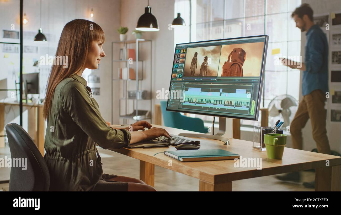 Beautiful Brunette Female Video Editor Works with Footage on Her ...