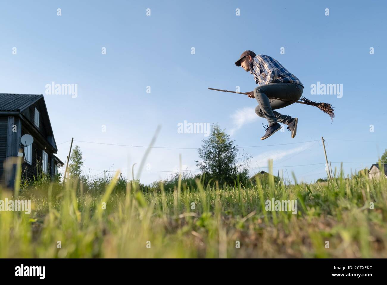 Man flying broomstick hi-res stock photography and images - Alamy
