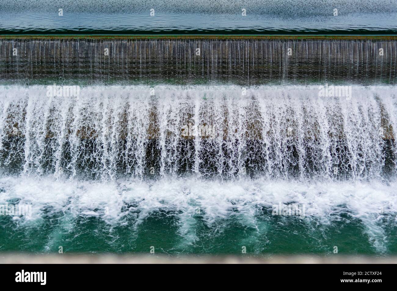 View from above of the flow of water rushing past the dam barrage Stock ...