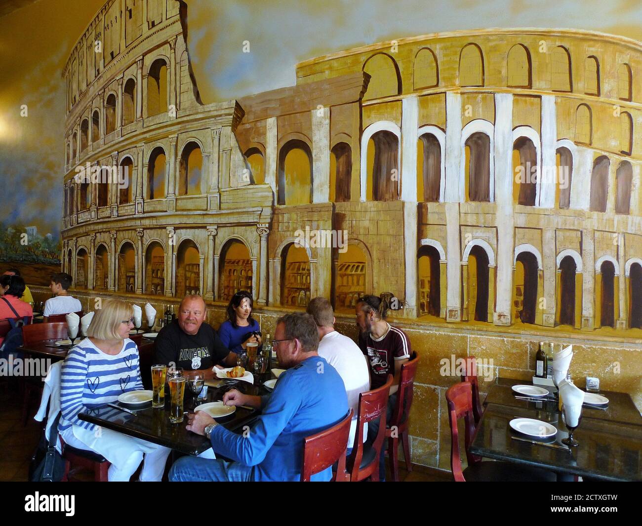 PEOPLE SITTING INSIDE AN ITALIAN RESTAURANTS WHOSE OWNER CAME FROM ROME ...