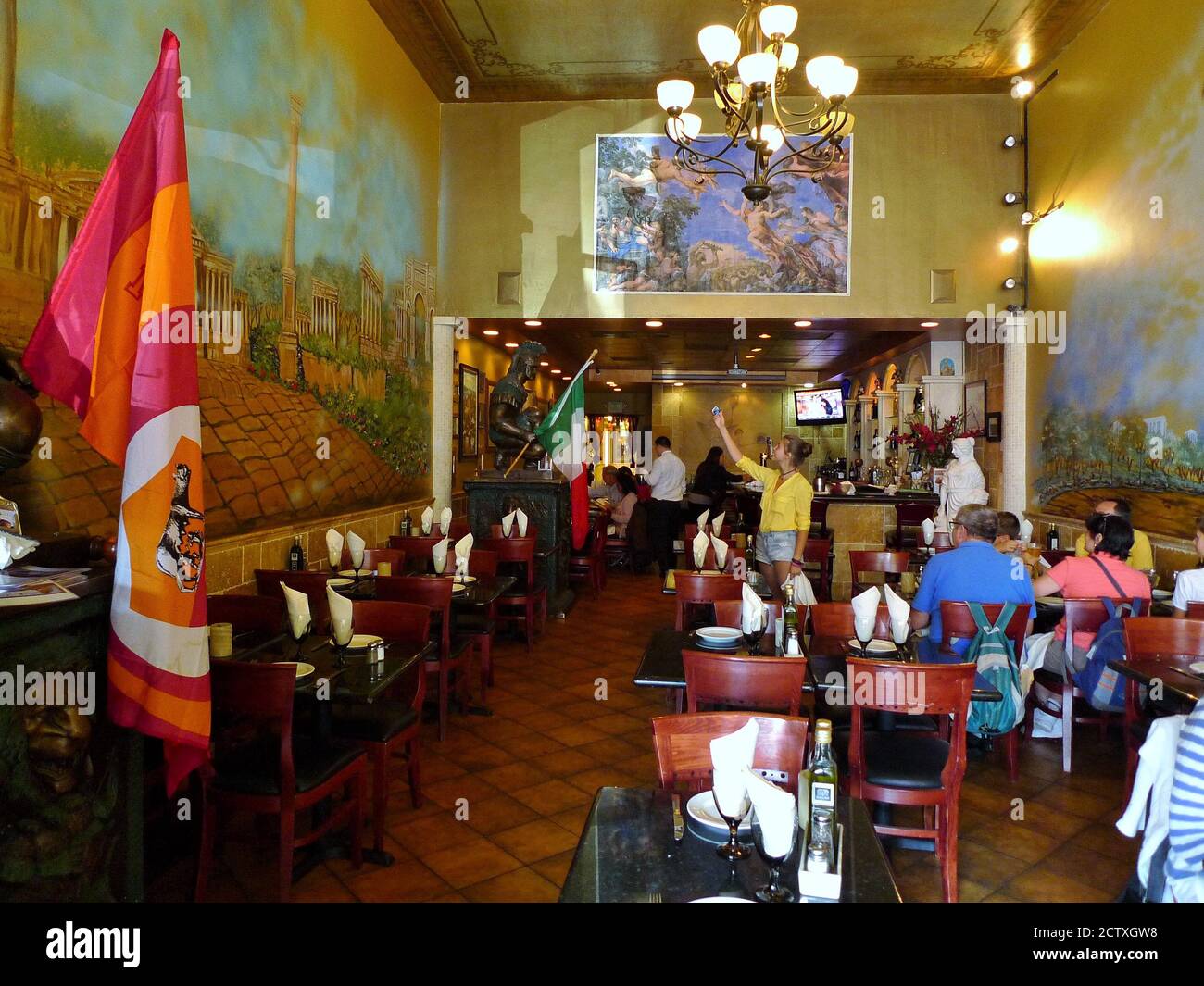 PEOPLE SITTING INSIDE AN ITALIAN RESTAURANTS WHOSE OWNER CAME FROM ROME ...