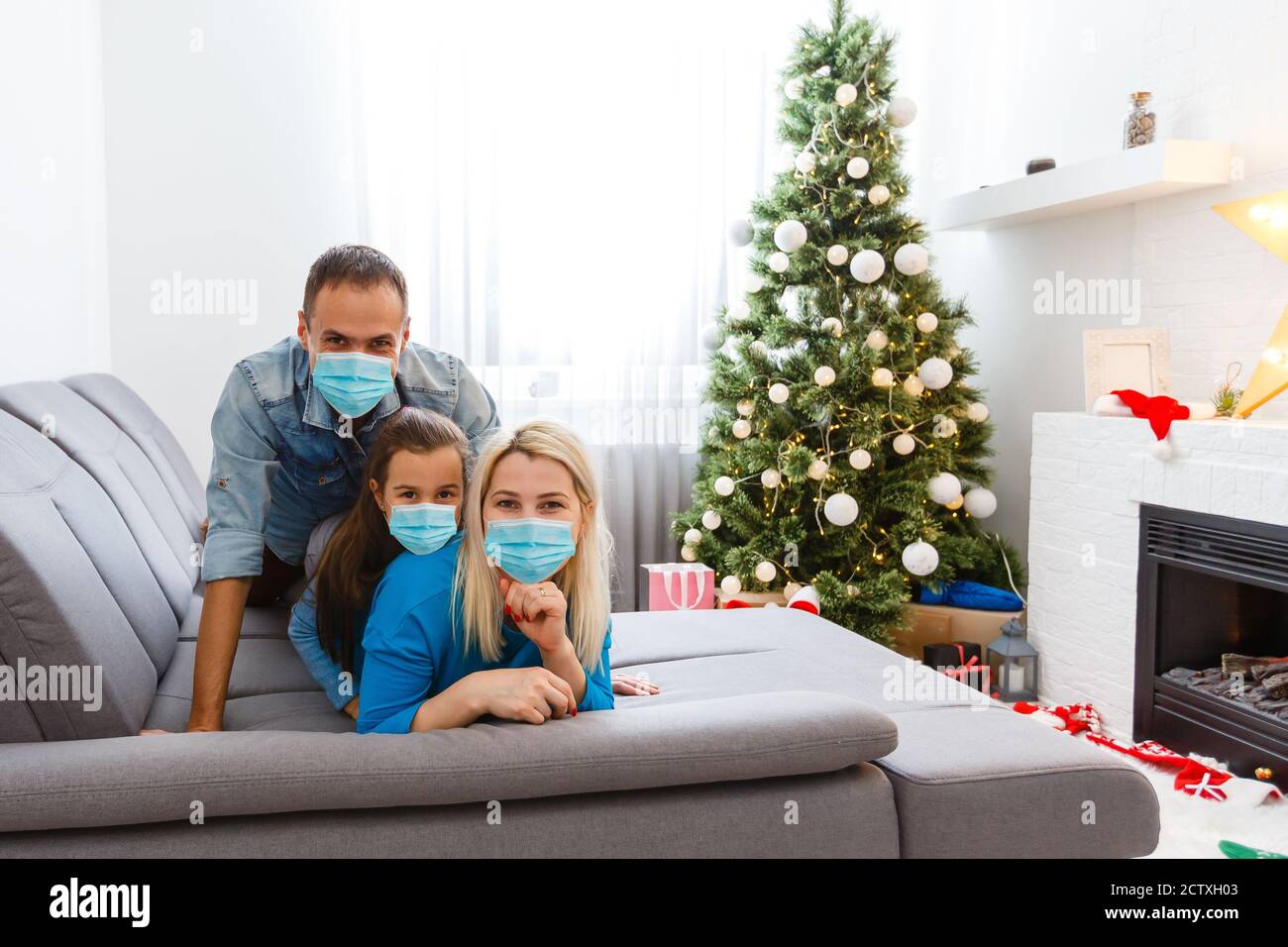 family in protective masks quarantined. Normal life with coronavirus ...