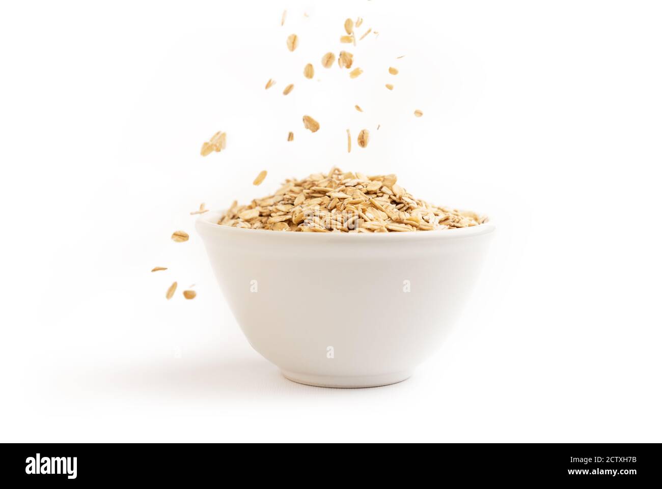 Front view of oat flakes on a ceramic bowl isolated on a white ...