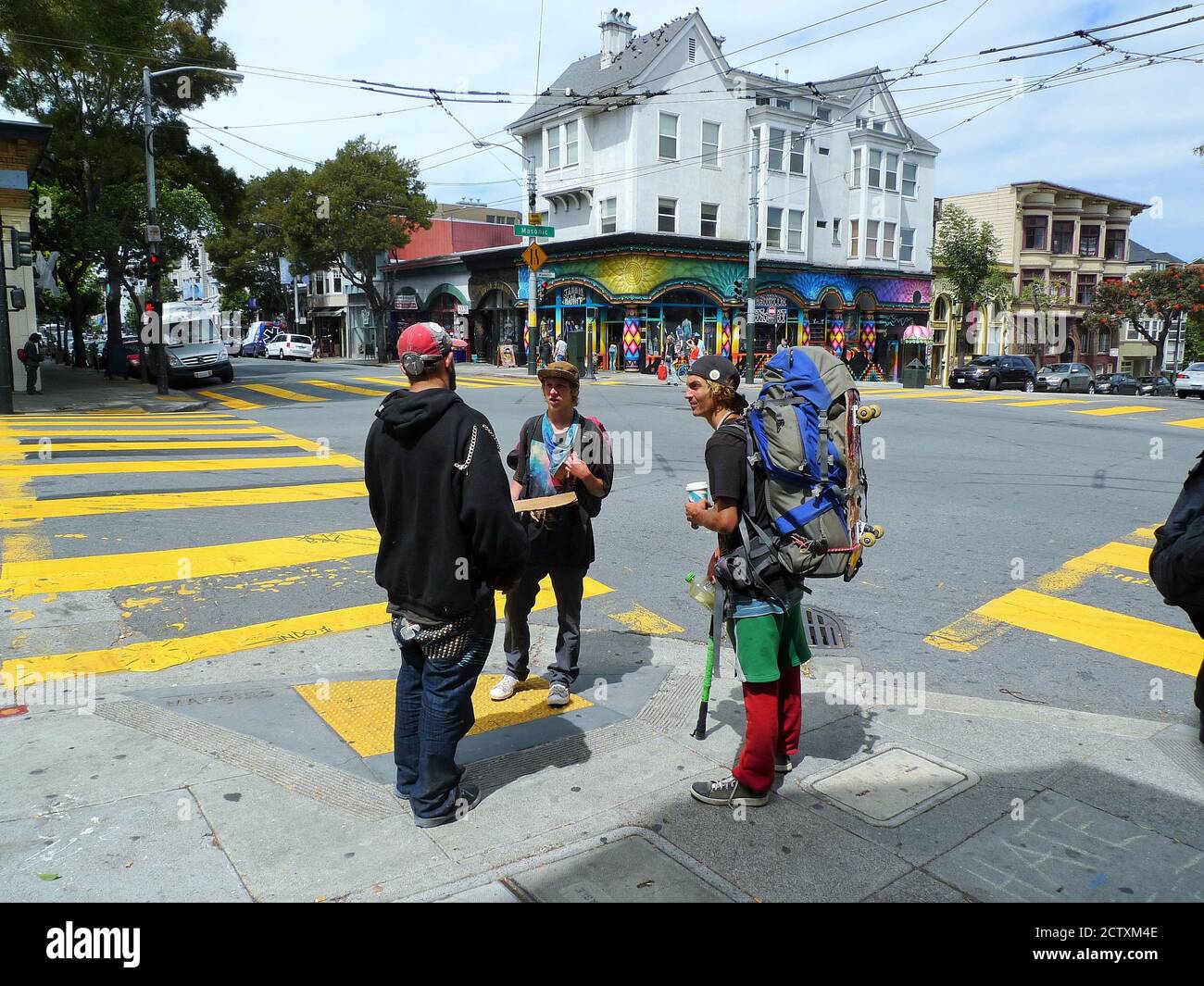 THREE BOYS TALK TO EACH OTHER IN A STREET IN THE HIPPY NEIGHBORHOOD OF ...