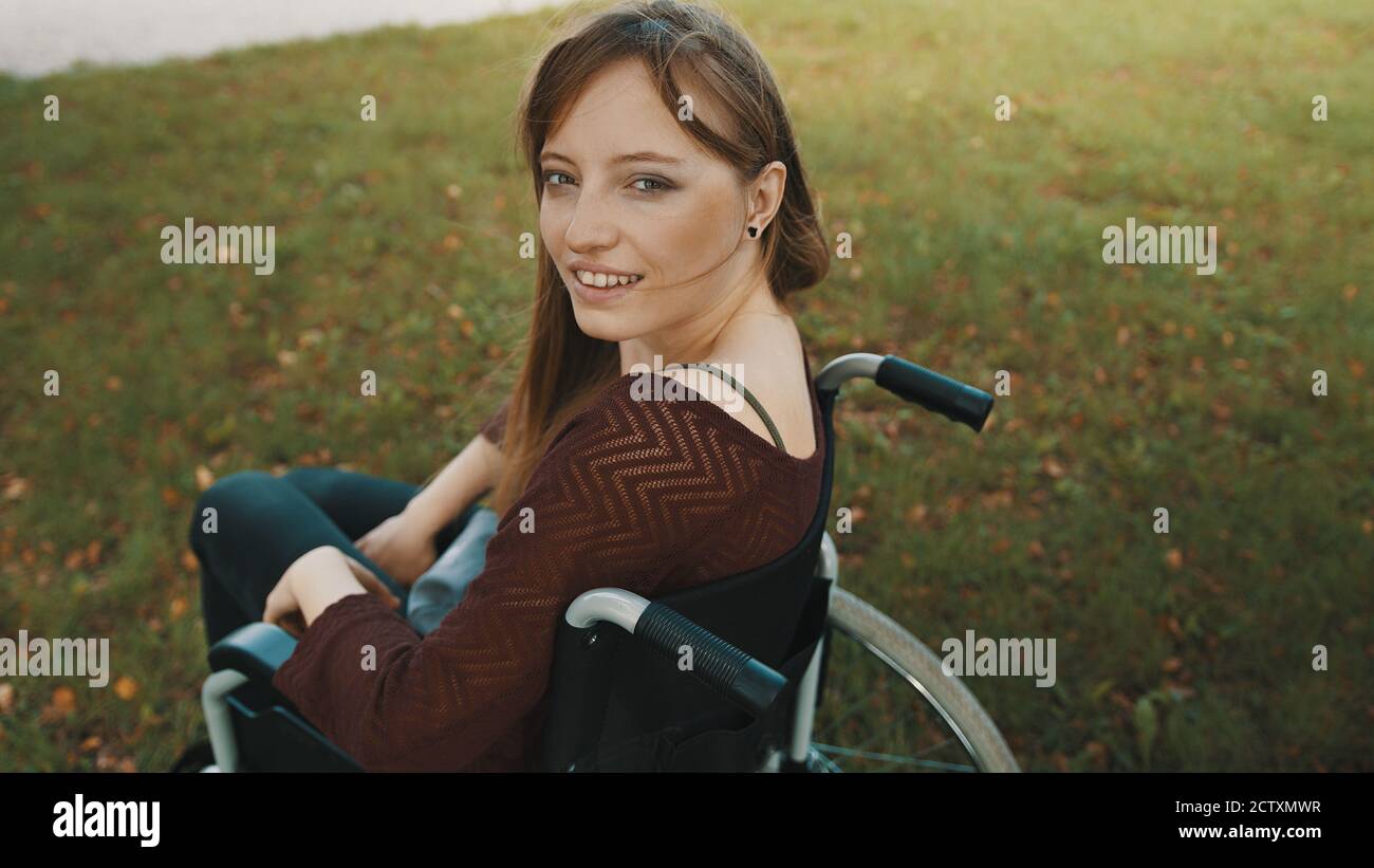 Beautiful disabled caucasian woman in the wheelchair looking over the ...