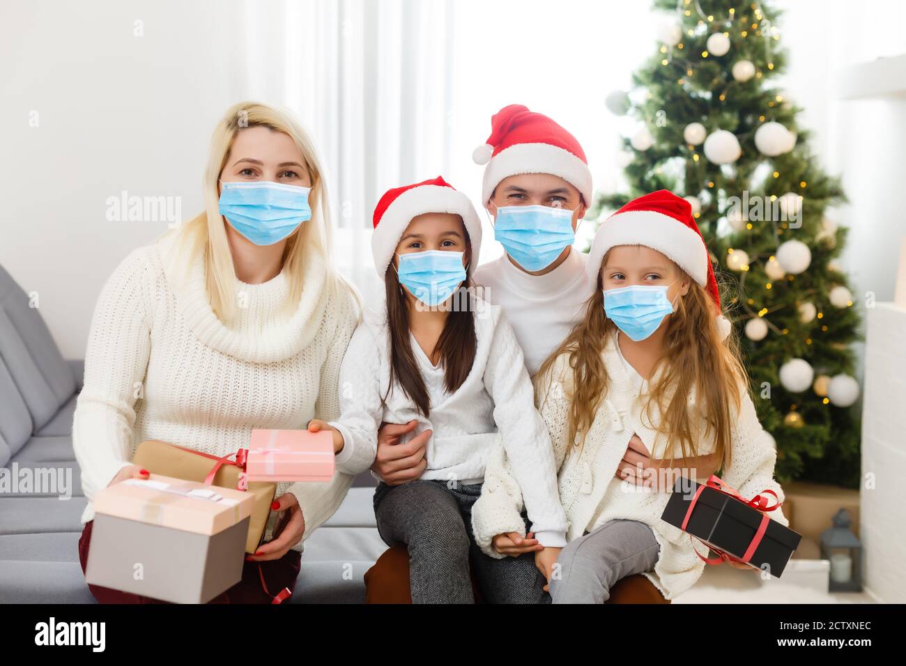 family in protective masks quarantined. Normal life with coronavirus ...