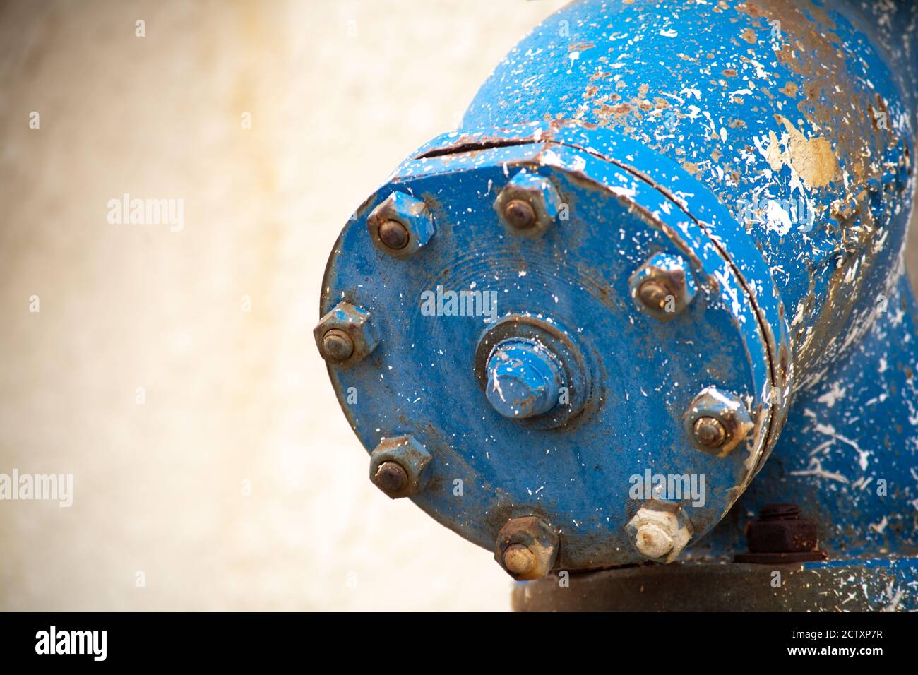 Blue rusted pipe joint with place to attach more pipes shows high ...